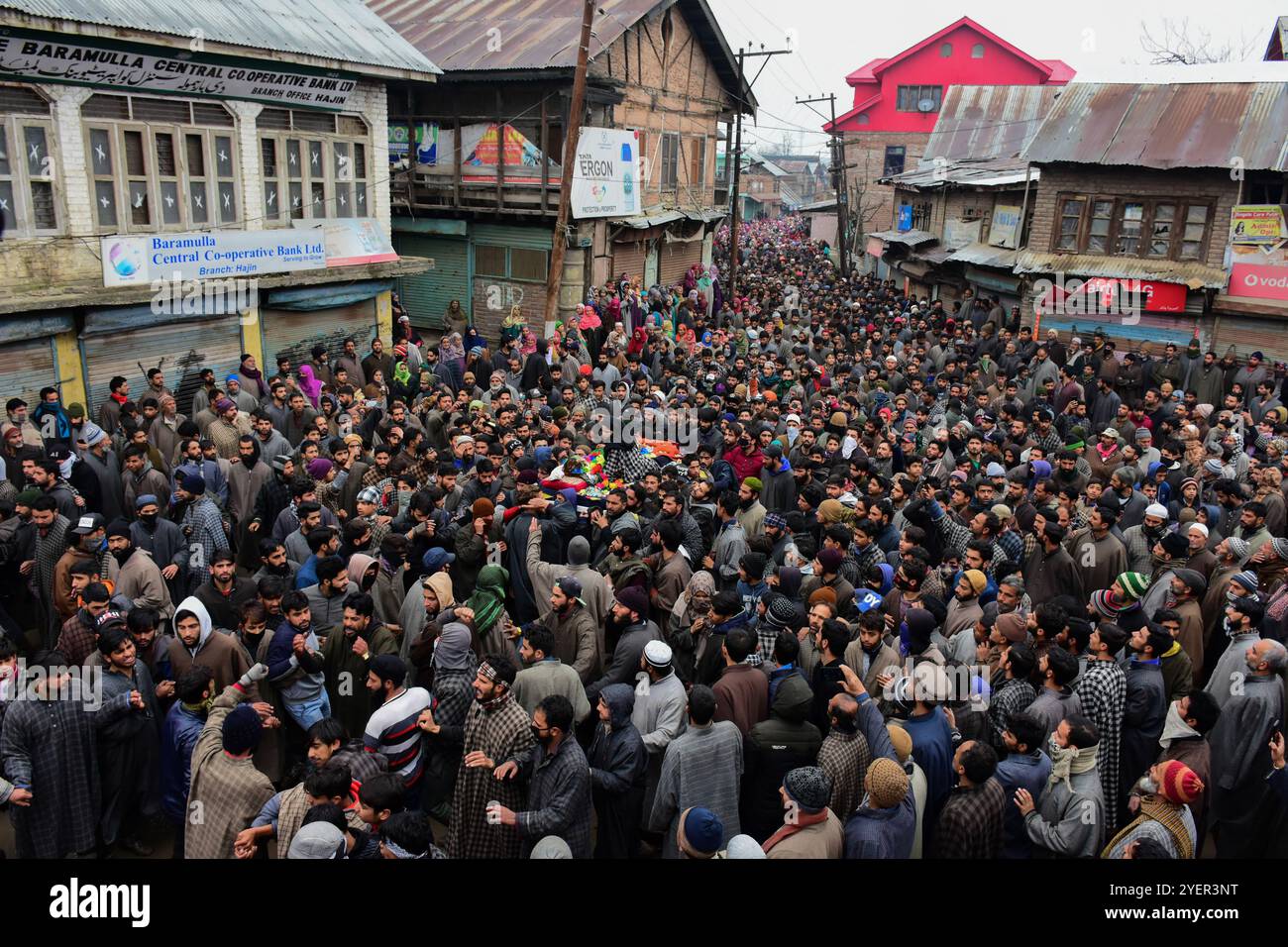 Thousands of mourners carry the body of alleged rebels Mudasir Parray, 14, and Mudasir Parray ...