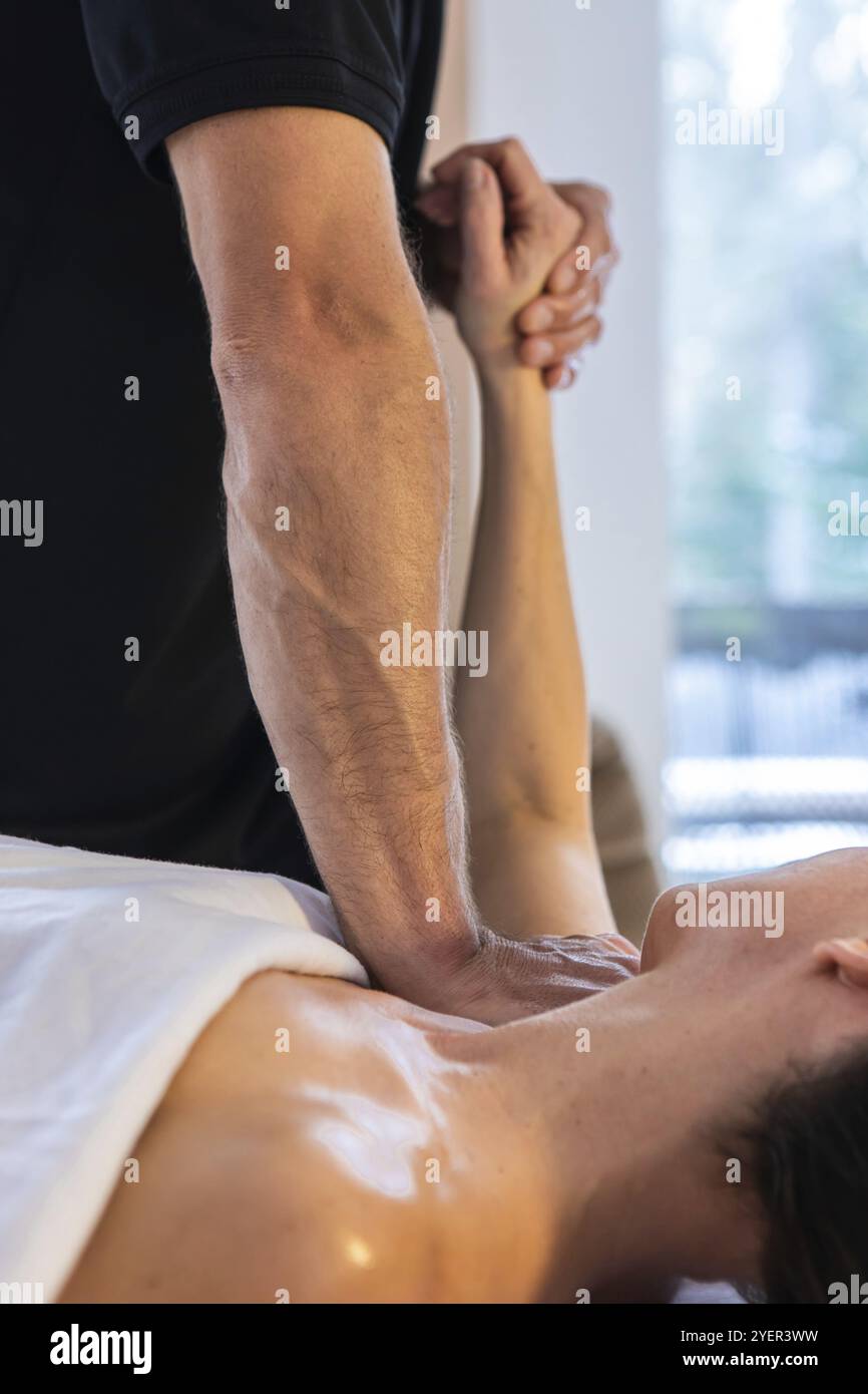 Professional massage therapist working on a woman hand. Woman receiving hand massage. Body ...