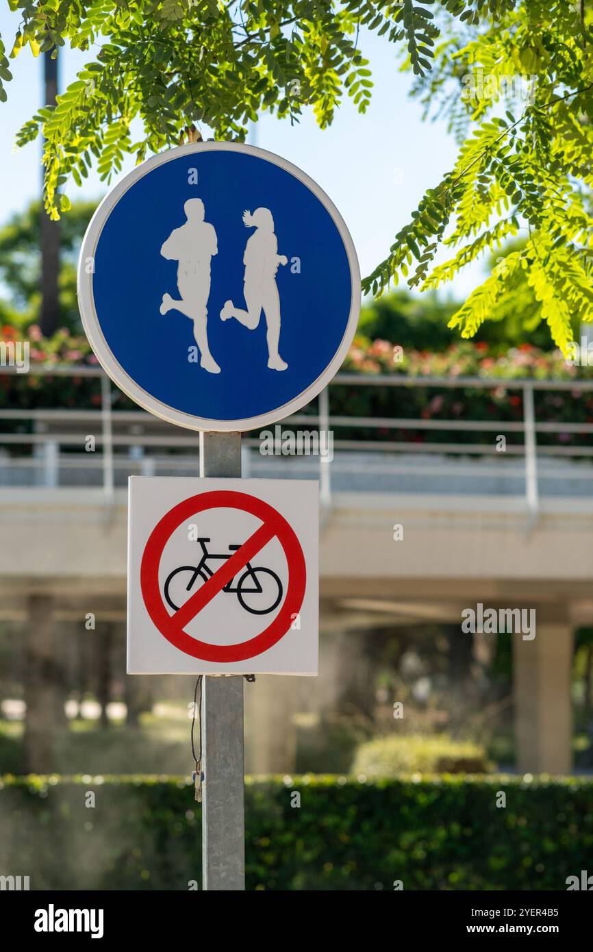 road signs bicycles prohibited and a treadmill in the park Stock Photo ...
