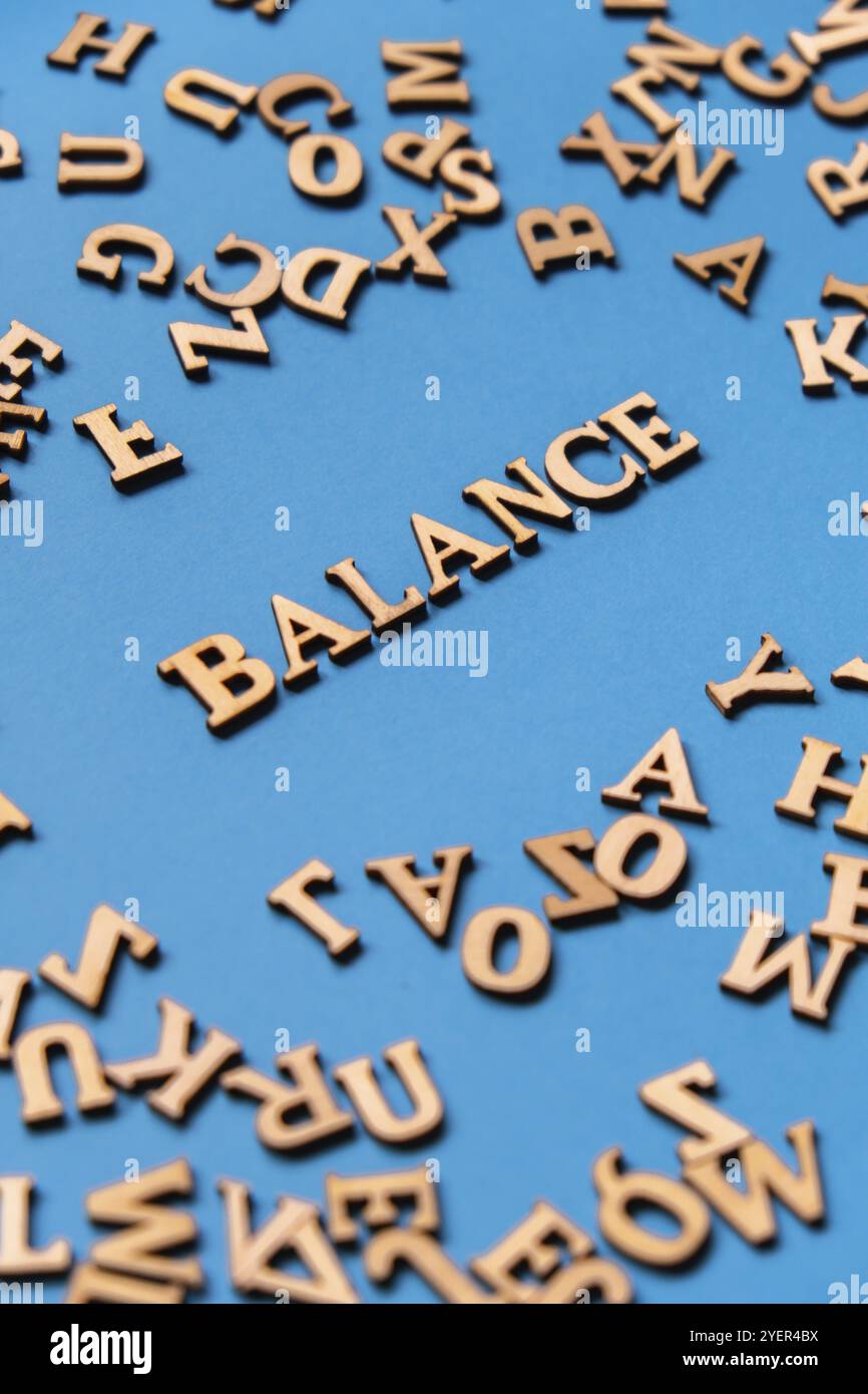 Word BALANCE made out of wooden letters on bright blue background ...