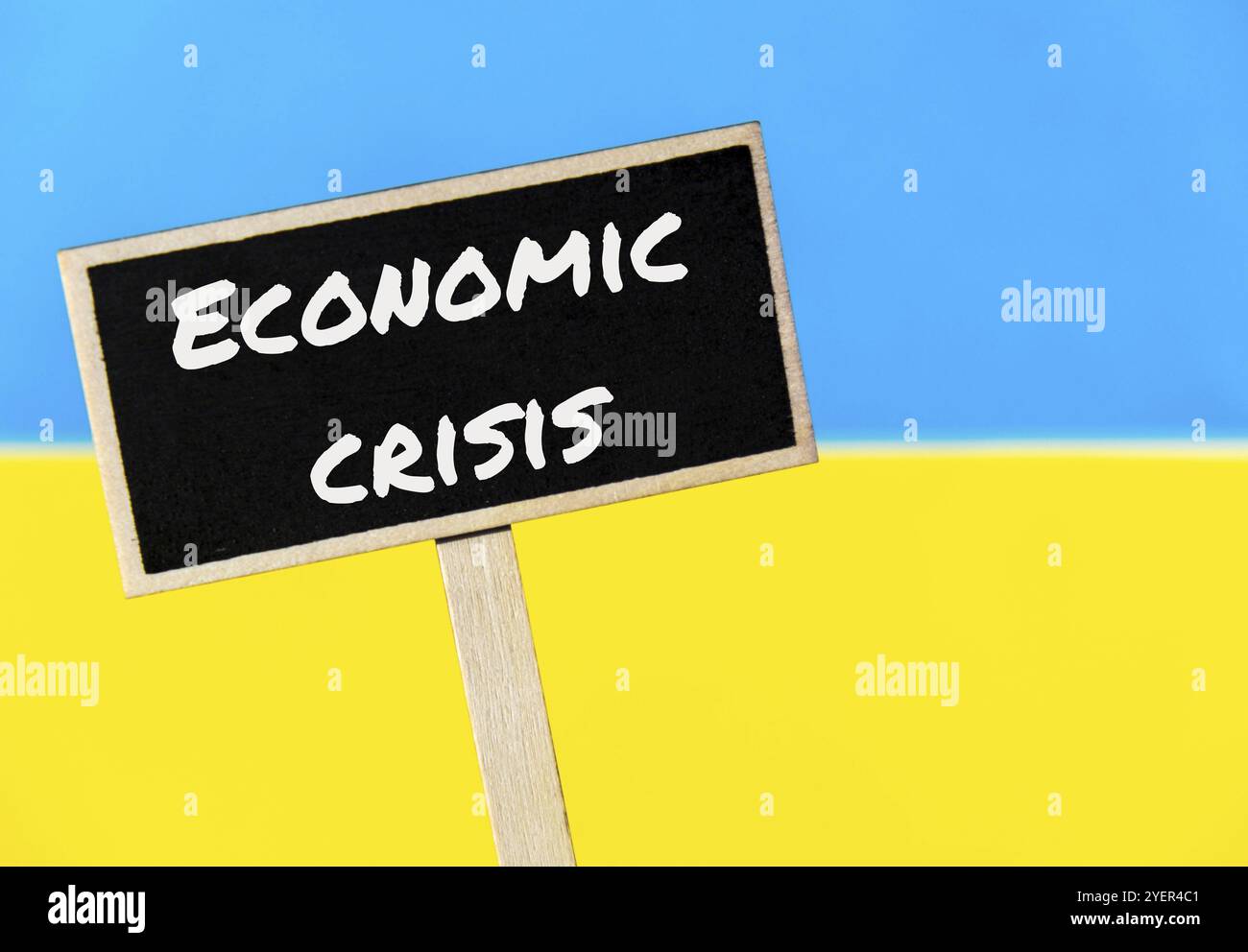 Wooden information label sign with text ECONOMIC CRISIS against ...