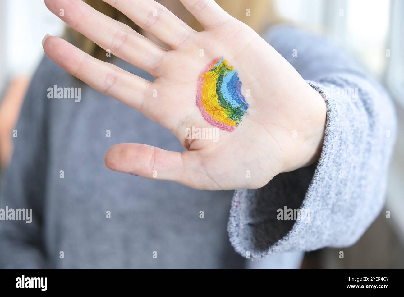 Rainbow LGBTQ flag painted on hand. Support for lgbt community. Honour ...