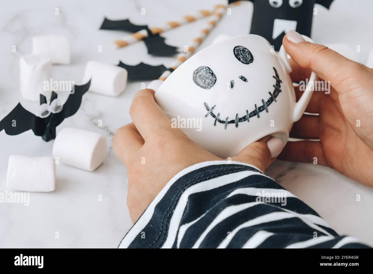 Female hands paint on white cup scary jacks face DIY for kids Halloween ...