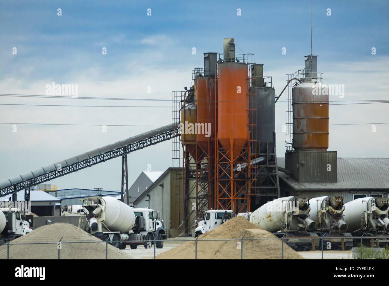 A wide angle view of a concrete batching and manufacture plant with aggregate conveyor, cement ...