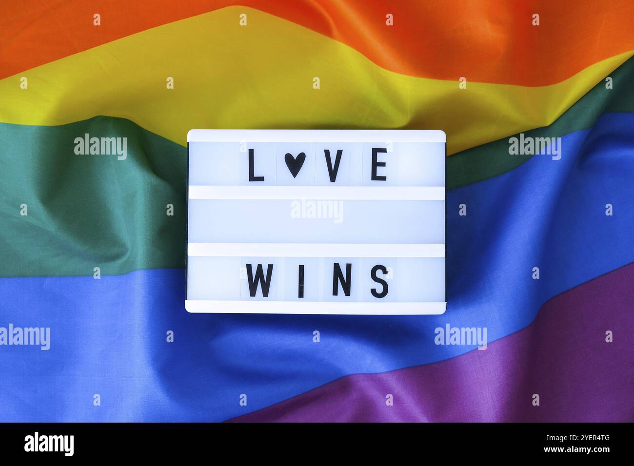 Rainbow flag with lightbox and text LOVE WINS. Rainbow lgbtq flag made ...