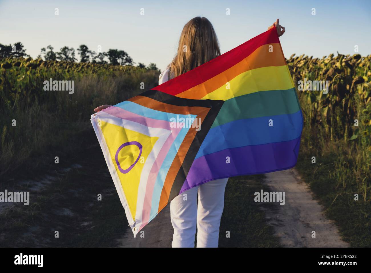 Symbol of LGBTQ pride month. Young woman showing Rainbow LGBTQIA flag ...