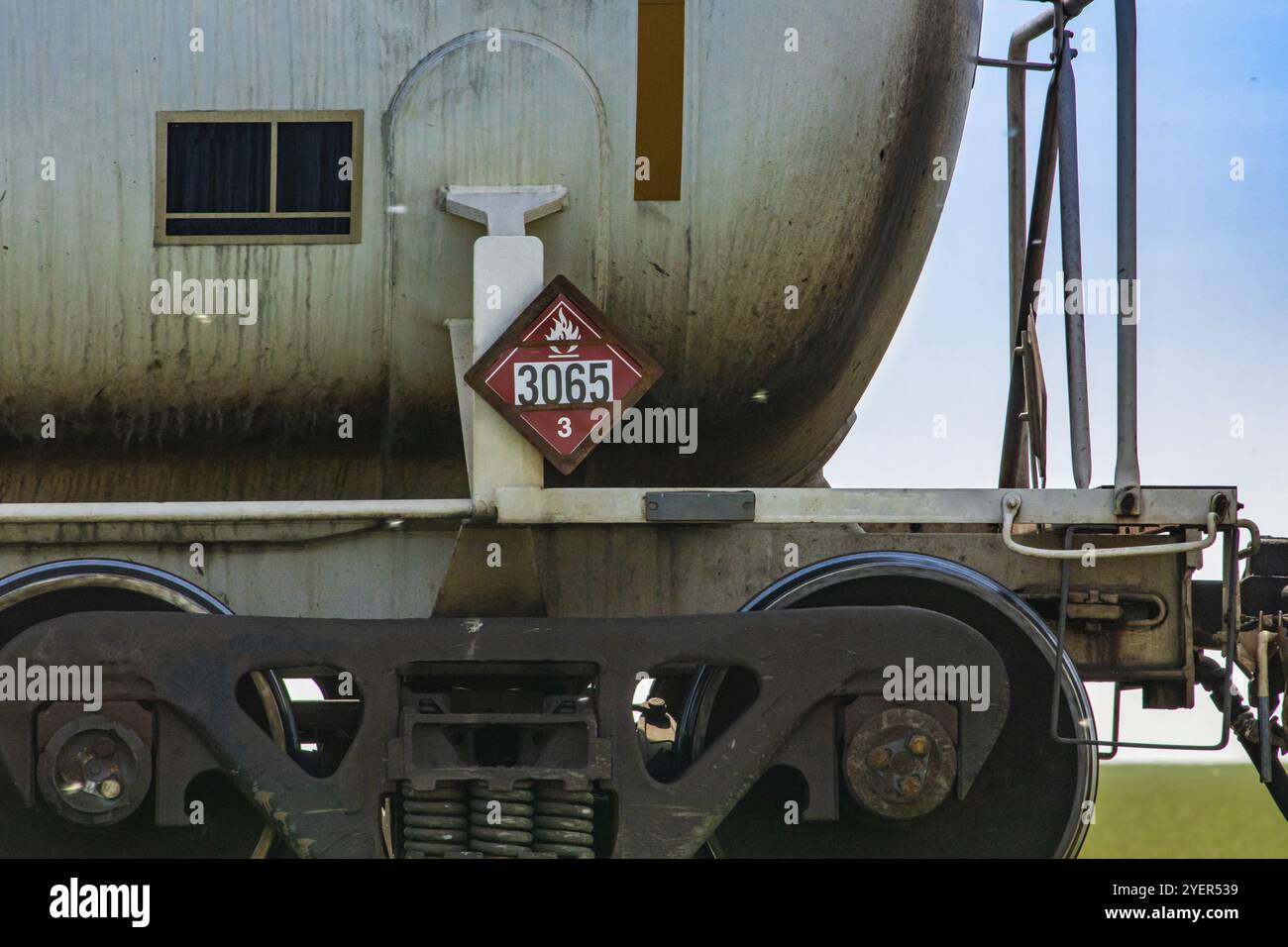 Close up of the tank car of a canadian freight train with 3065 warning ...