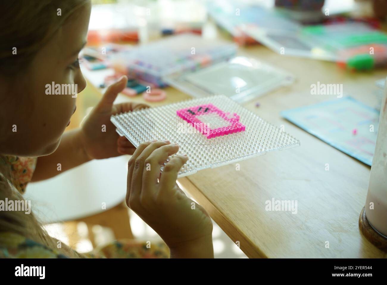 Teacher in workshop teched two girls how to assemble a thermo mosaic ...