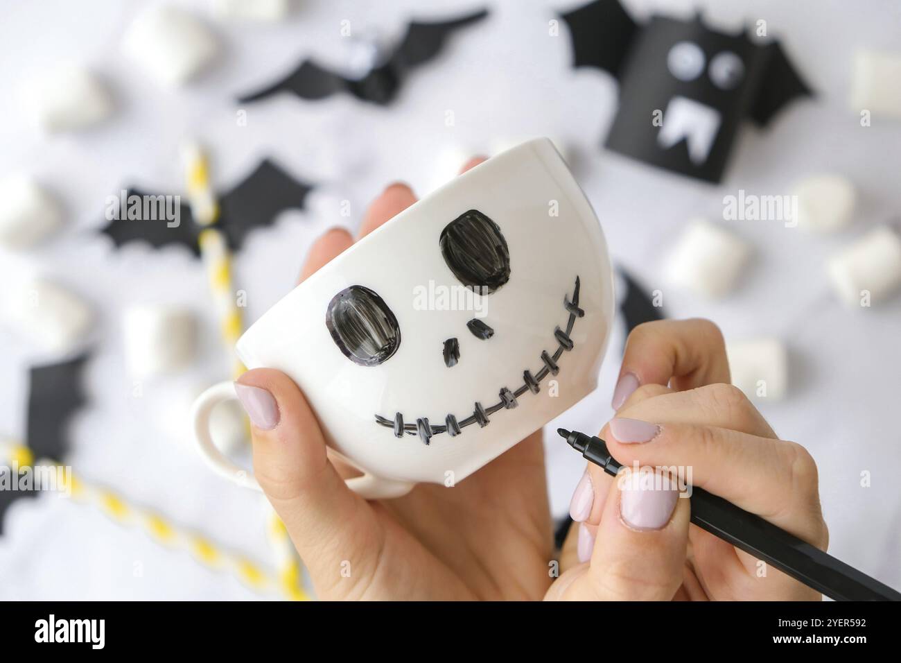 Female hands paint on white cup scary jacks face DIY for kids Halloween ...