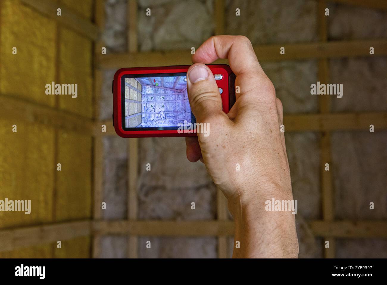 Home inspector photographing timber frame building cavity walls filled ...