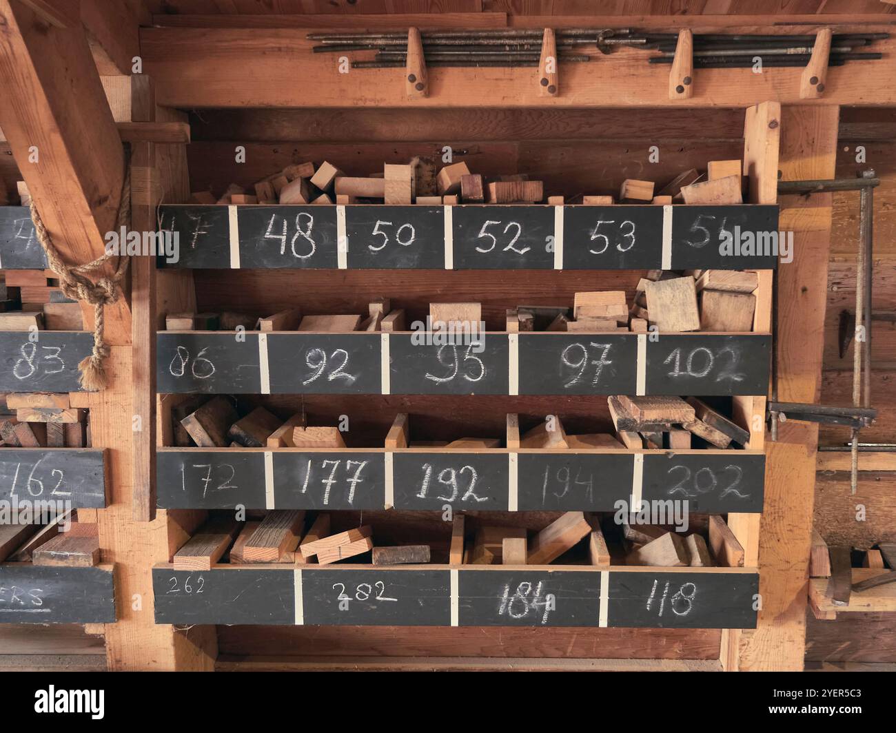 An organized wooden storage shelf in a Dutch sawmill, displaying ...