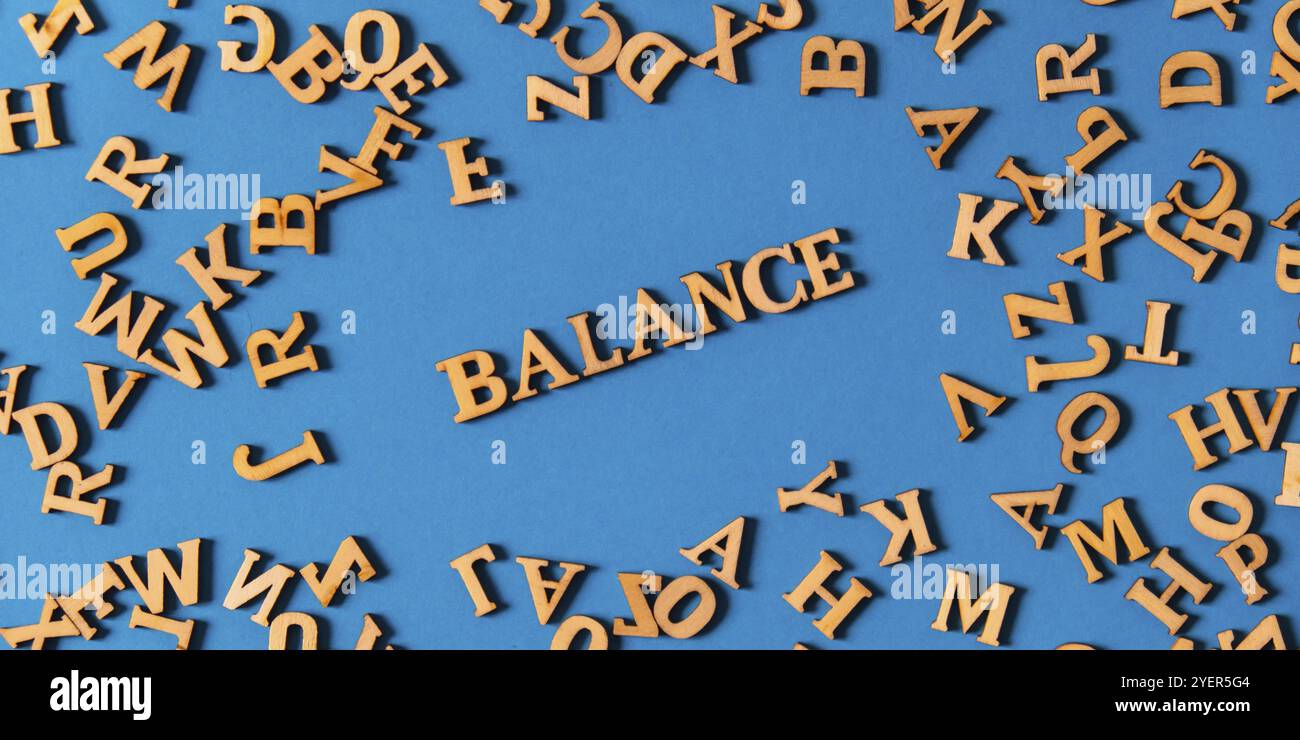 Word BALANCE made out of wooden letters on bright blue background ...
