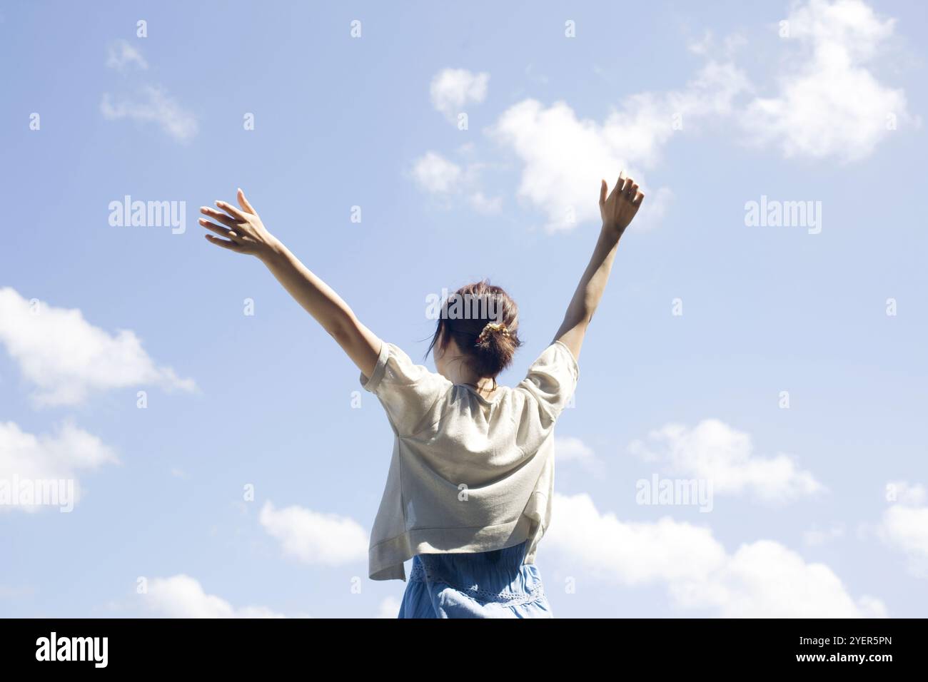Back view woman raising hi-res stock photography and images - Alamy