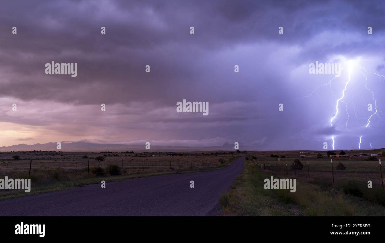 An electrical storm passes over farm land in Arizona Territory ...