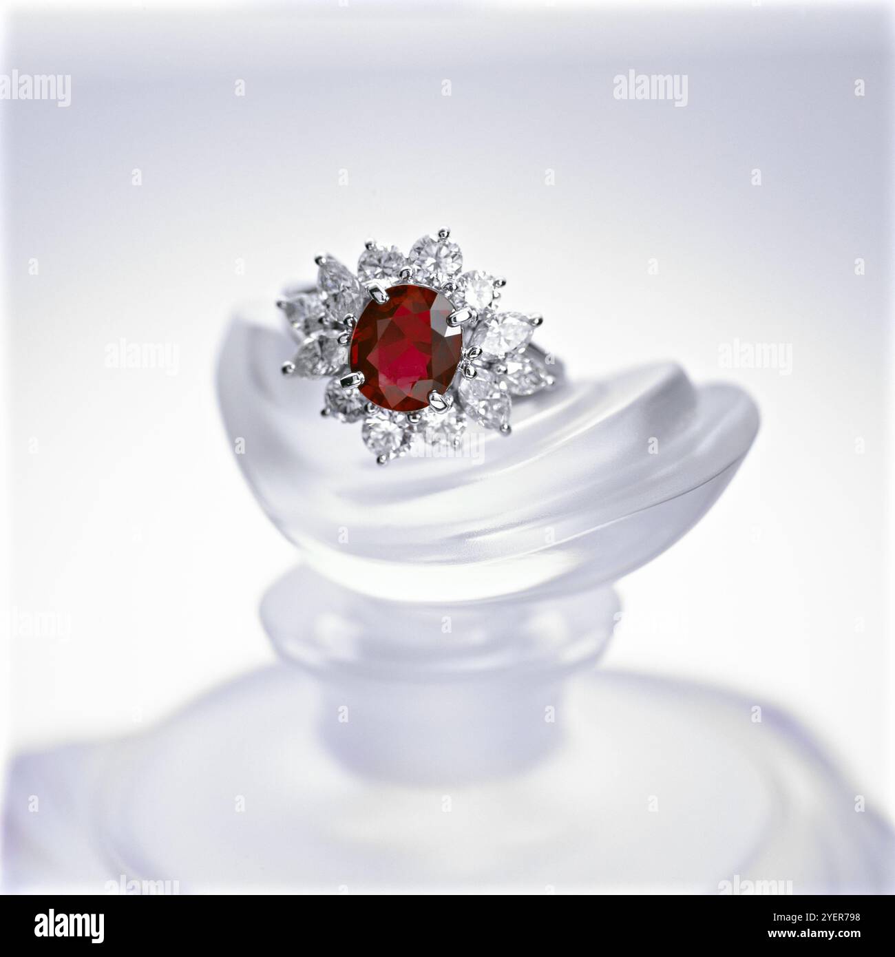 Ruby ring adorned with diamonds on top of a perfume bottle Stock Photo ...
