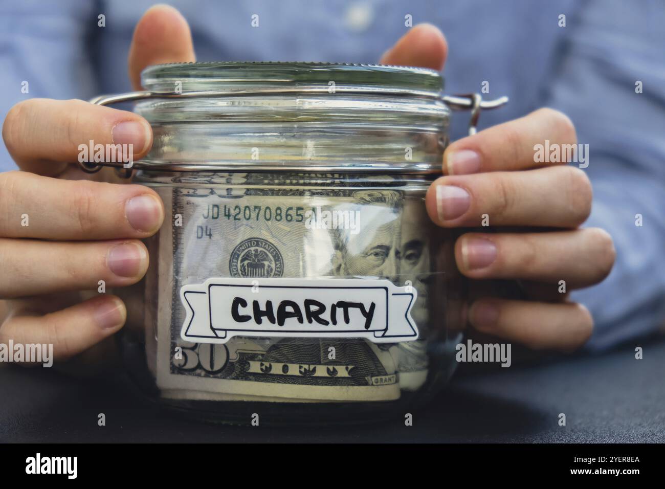 Woman holding jar full money hi-res stock photography and images - Alamy
