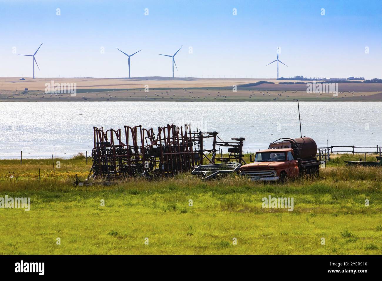 A wide angle view of outdated rusty farm equipment stored in a ...
