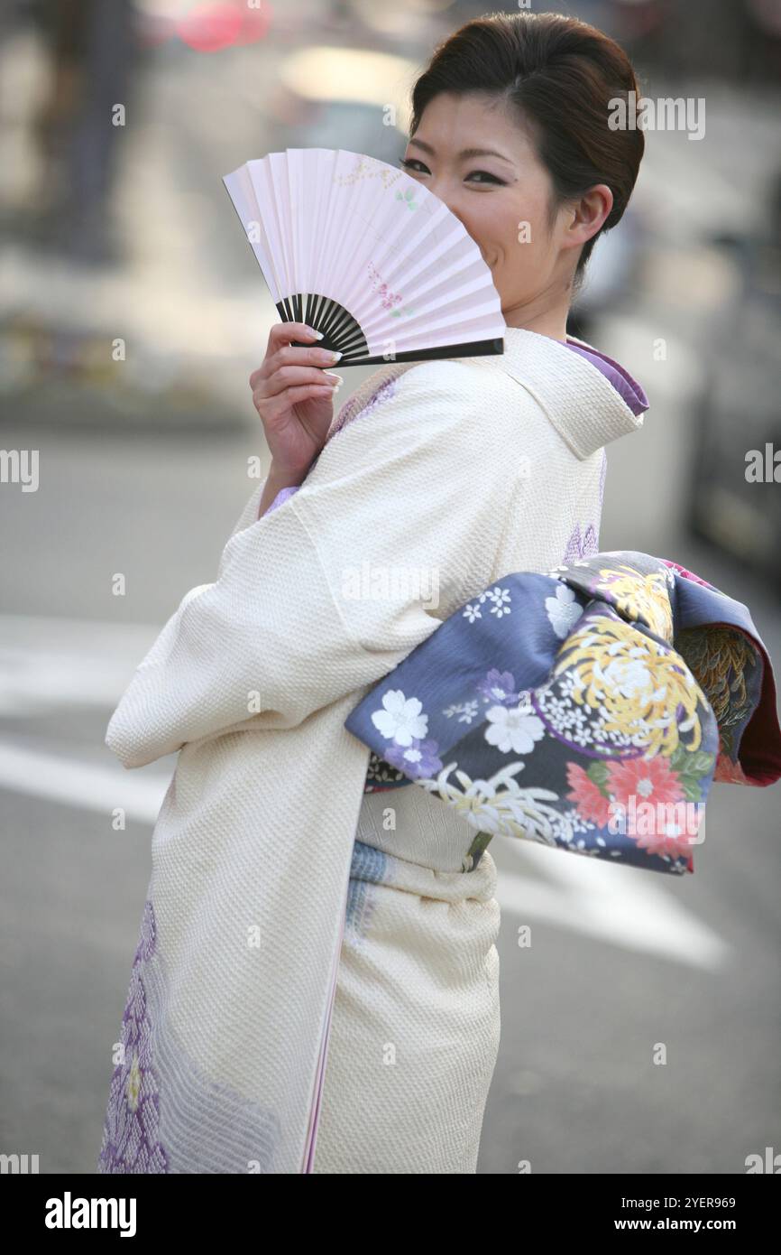 Woman covering face hand fan hi-res stock photography and images - Alamy