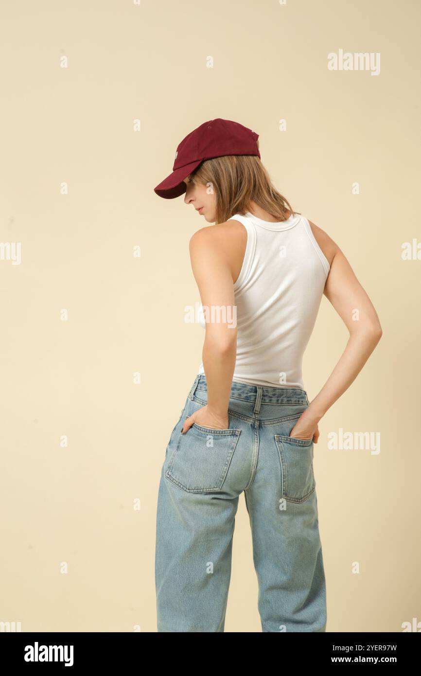 Serie of studio photos of woman in classic basic outfit - blue jeans and white tank top and red ...