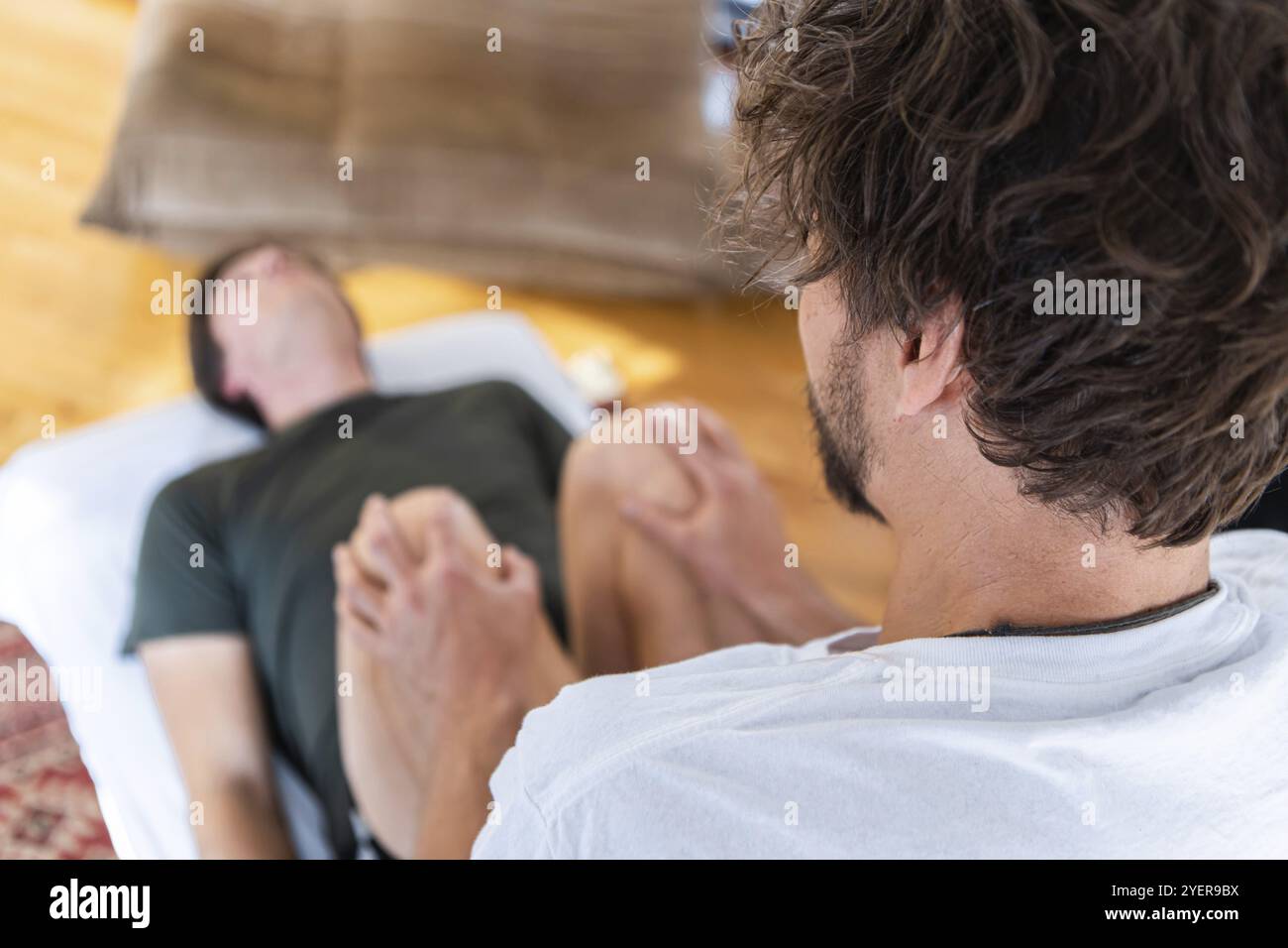 Young man having feet massage in the spa salon after sports. A strong ...