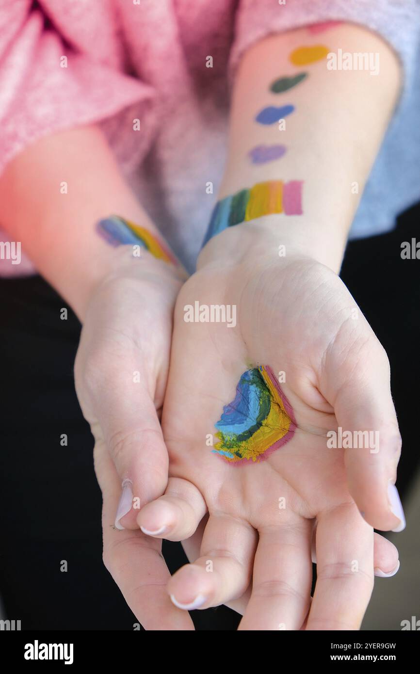 Rainbow LGBTQ flag painted on hand. Support for lgbt community. Honour ...