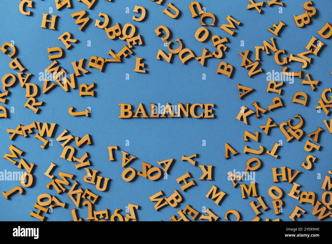 Word BALANCE made out of wooden letters on bright blue background ...