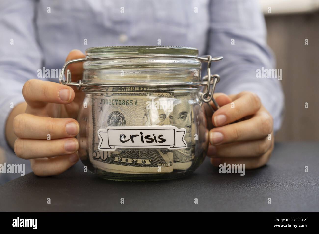 Female hands holding Glass jar full of American currency dollars cash ...