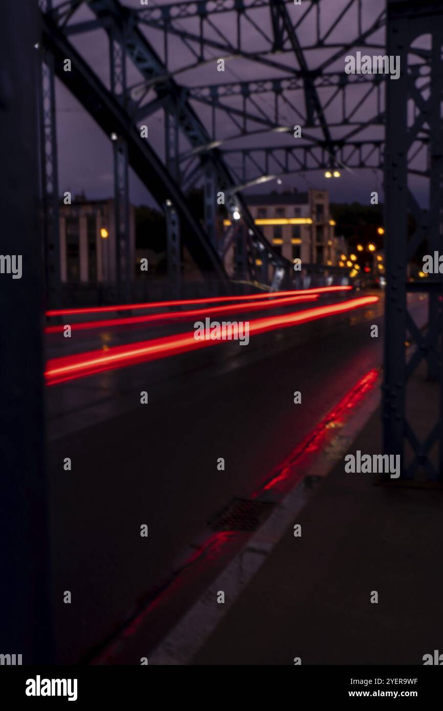 Defocused Lights of cars at night in Krakow bridge. Street line lights ...