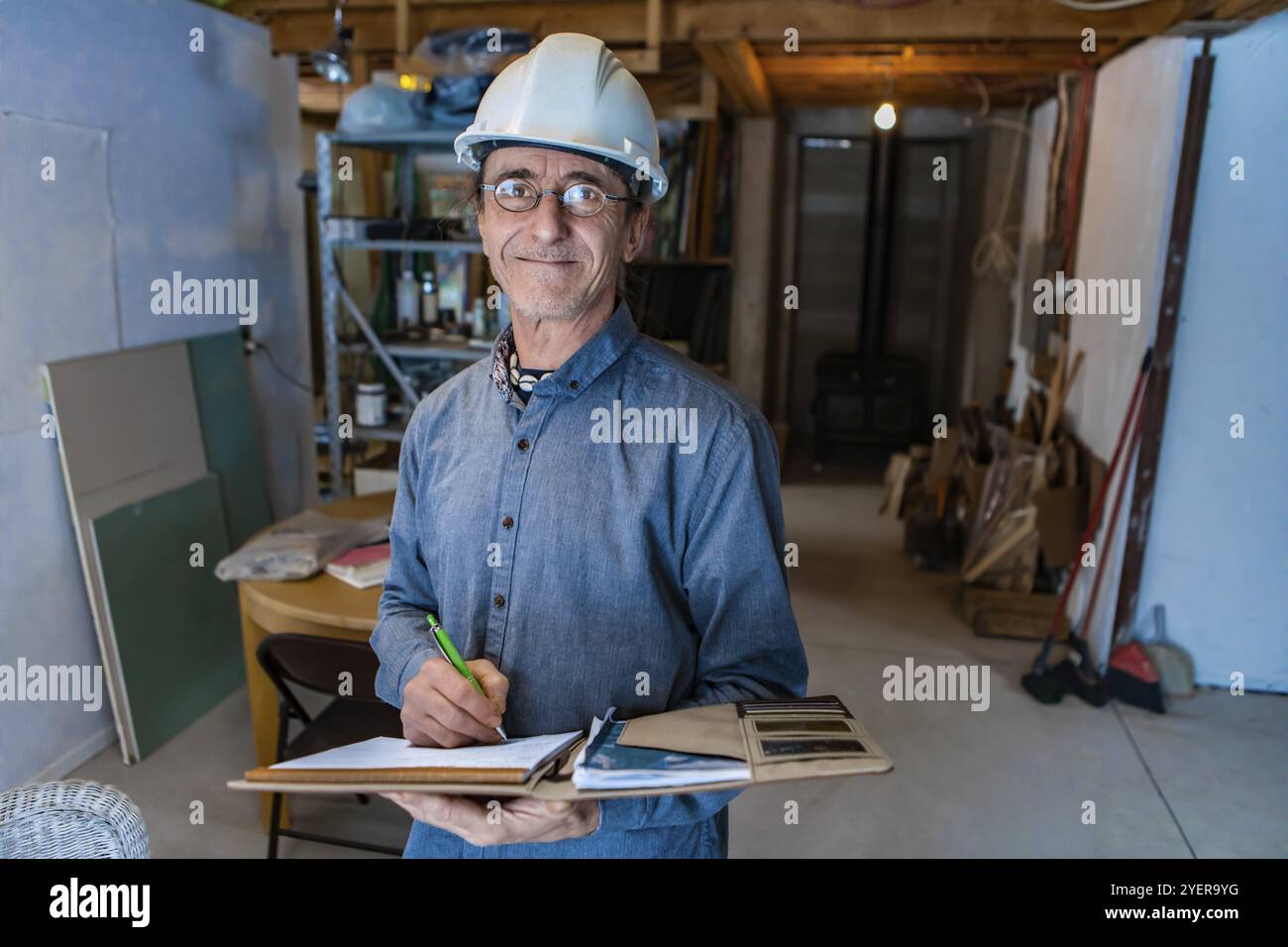 Inspector wearing a safety helmet in the basement during a home ...