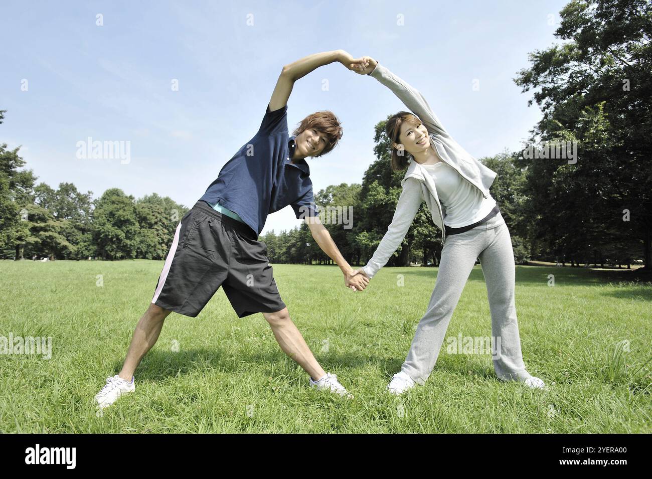 Man and woman doing preparatory exercise Stock Photo - Alamy