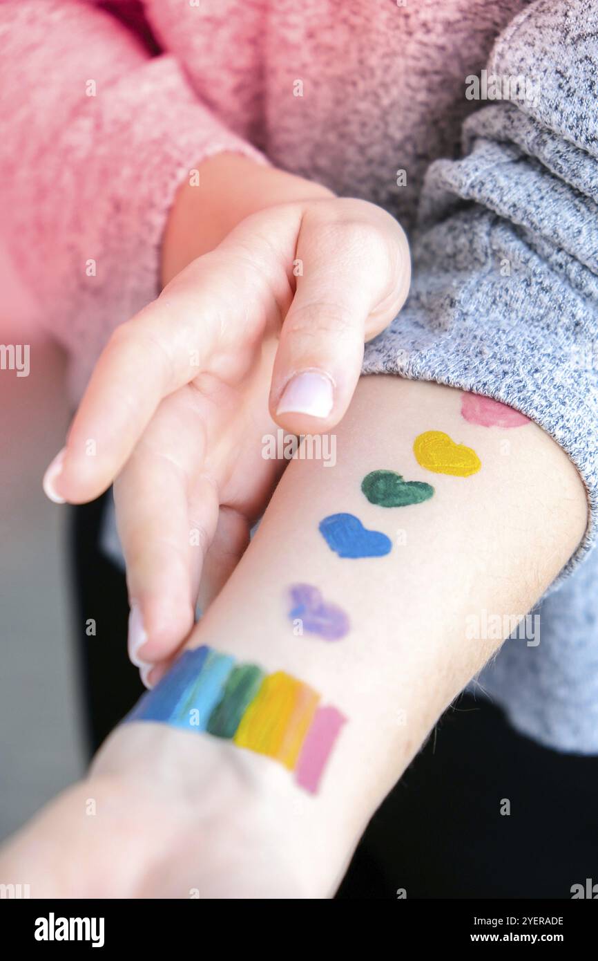 Rainbow LGBTQ flag painted on hand. Support for lgbt community. Honour ...