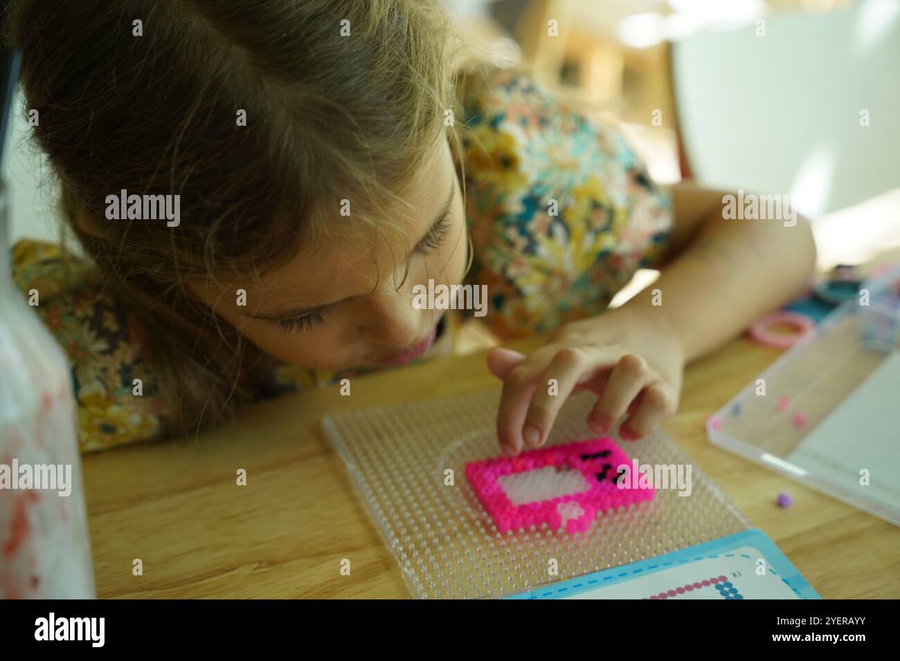 Teacher in workshop teched two girls how to assemble a thermo mosaic ...