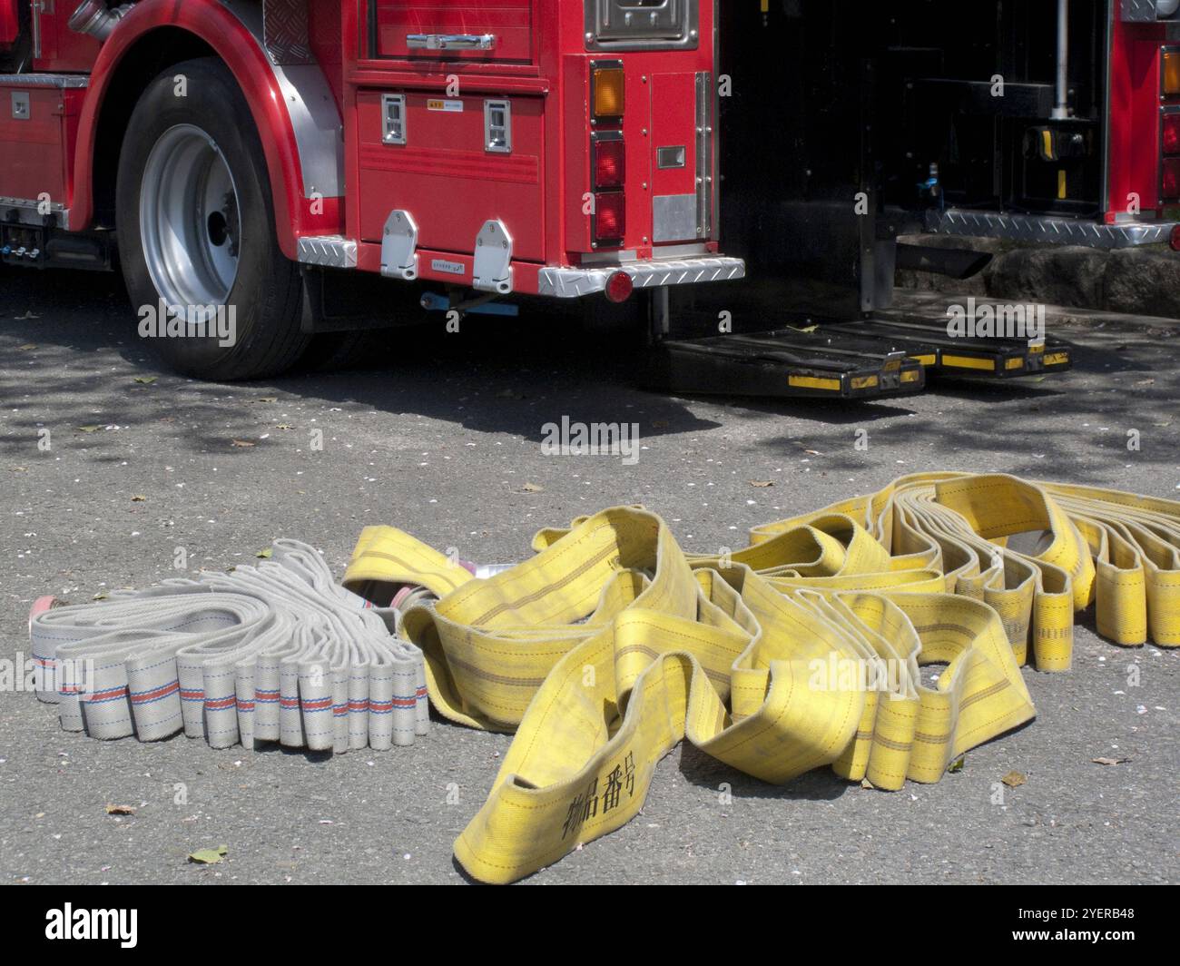 Fire engine and water hose Stock Photo - Alamy