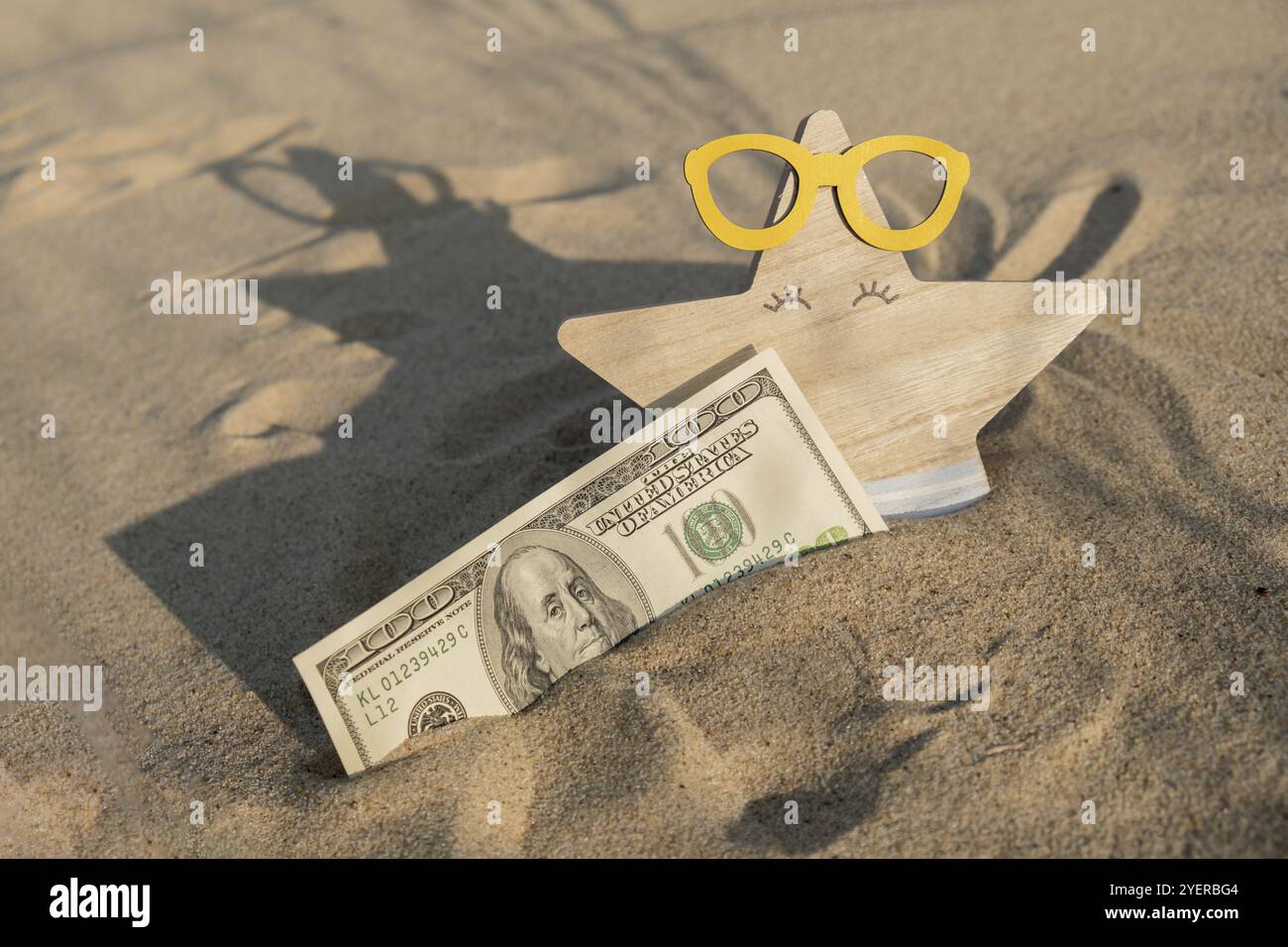 Dollar in sand hi-res stock photography and images - Alamy