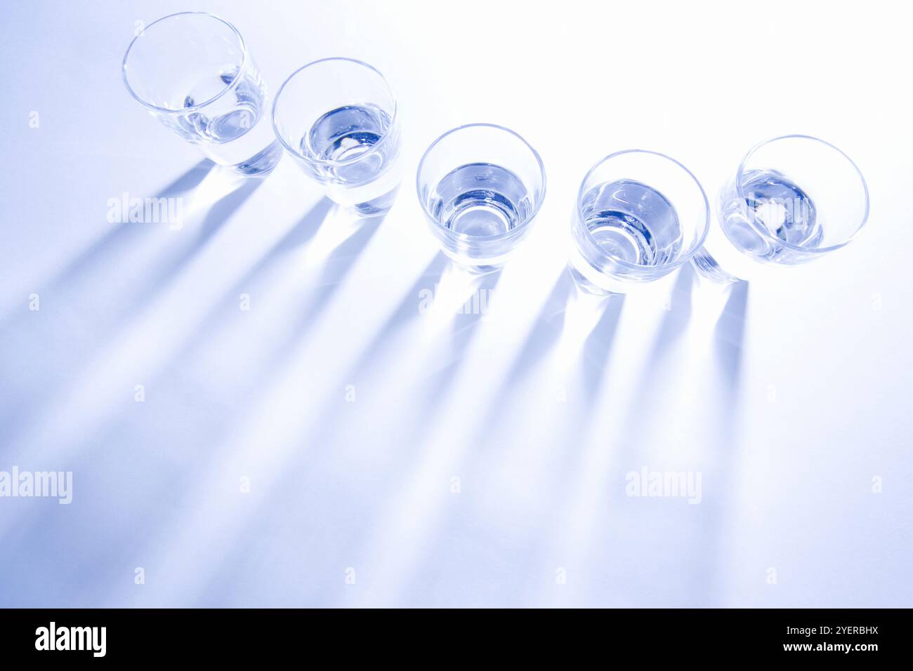Five glasses filled with water Stock Photo - Alamy
