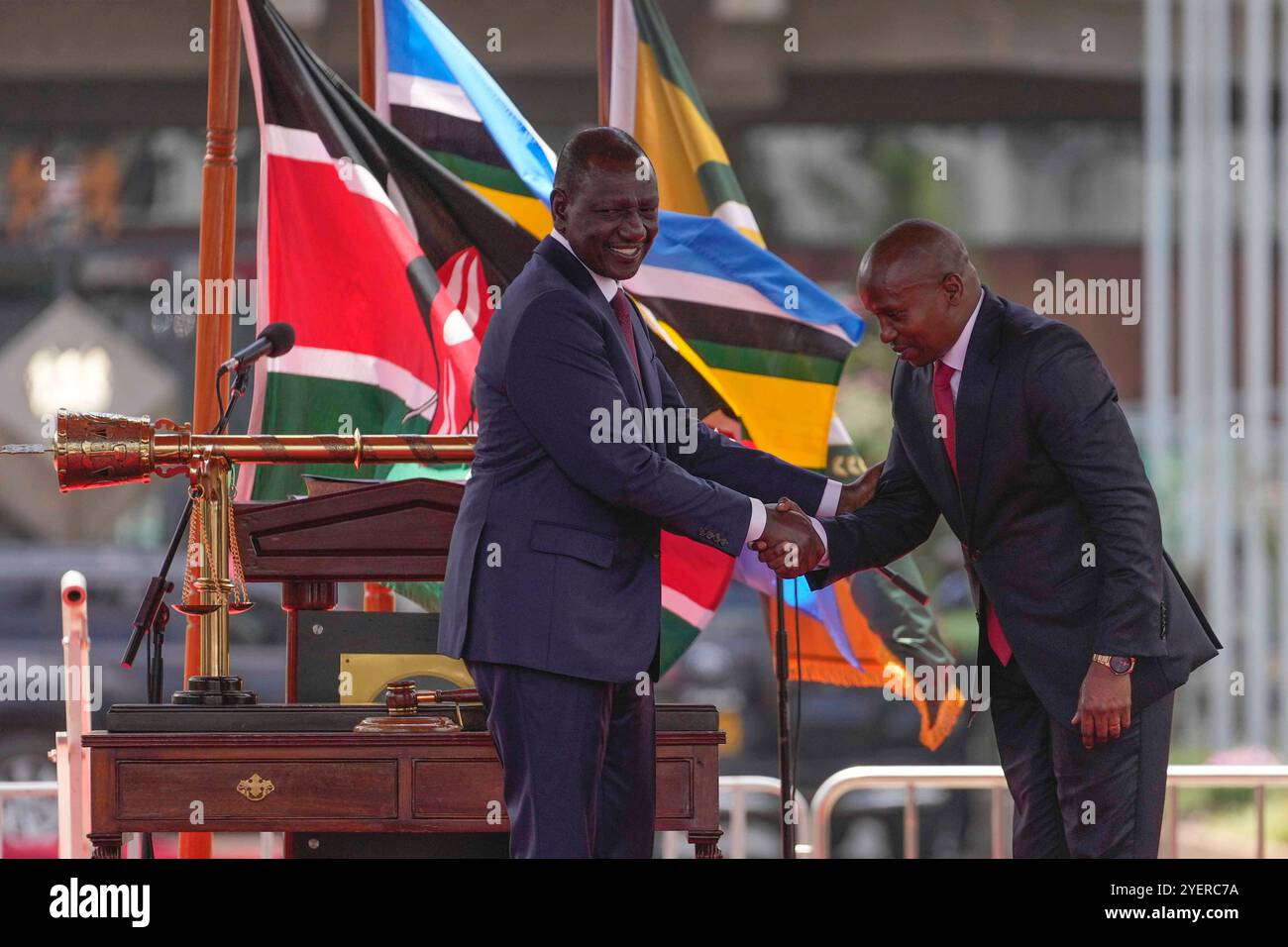 Kenya's new Deputy President Kithure Kindiki, right, shakes hands with Kenya's President William ...