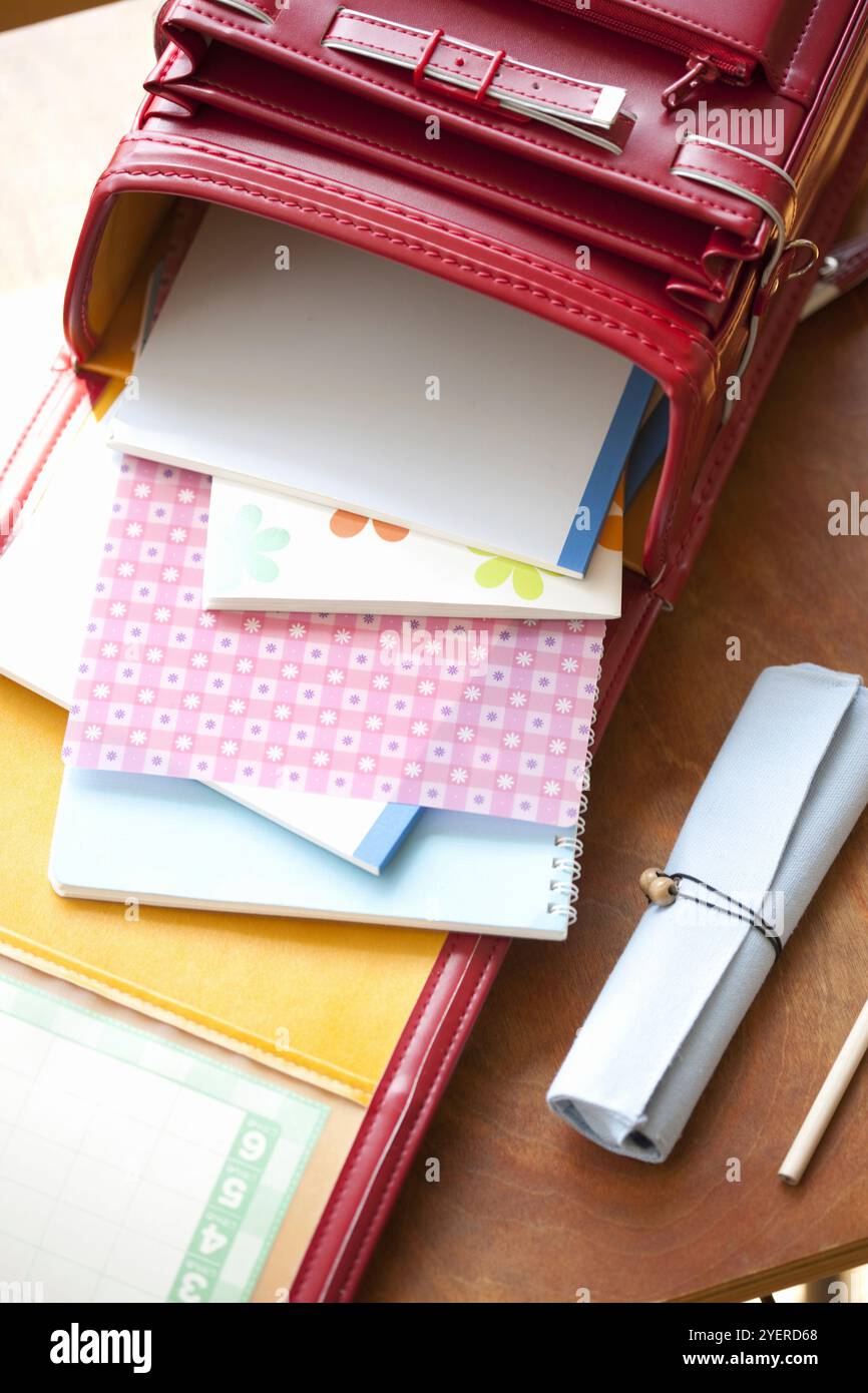 School bags and writing materials on a desk Stock Photo - Alamy