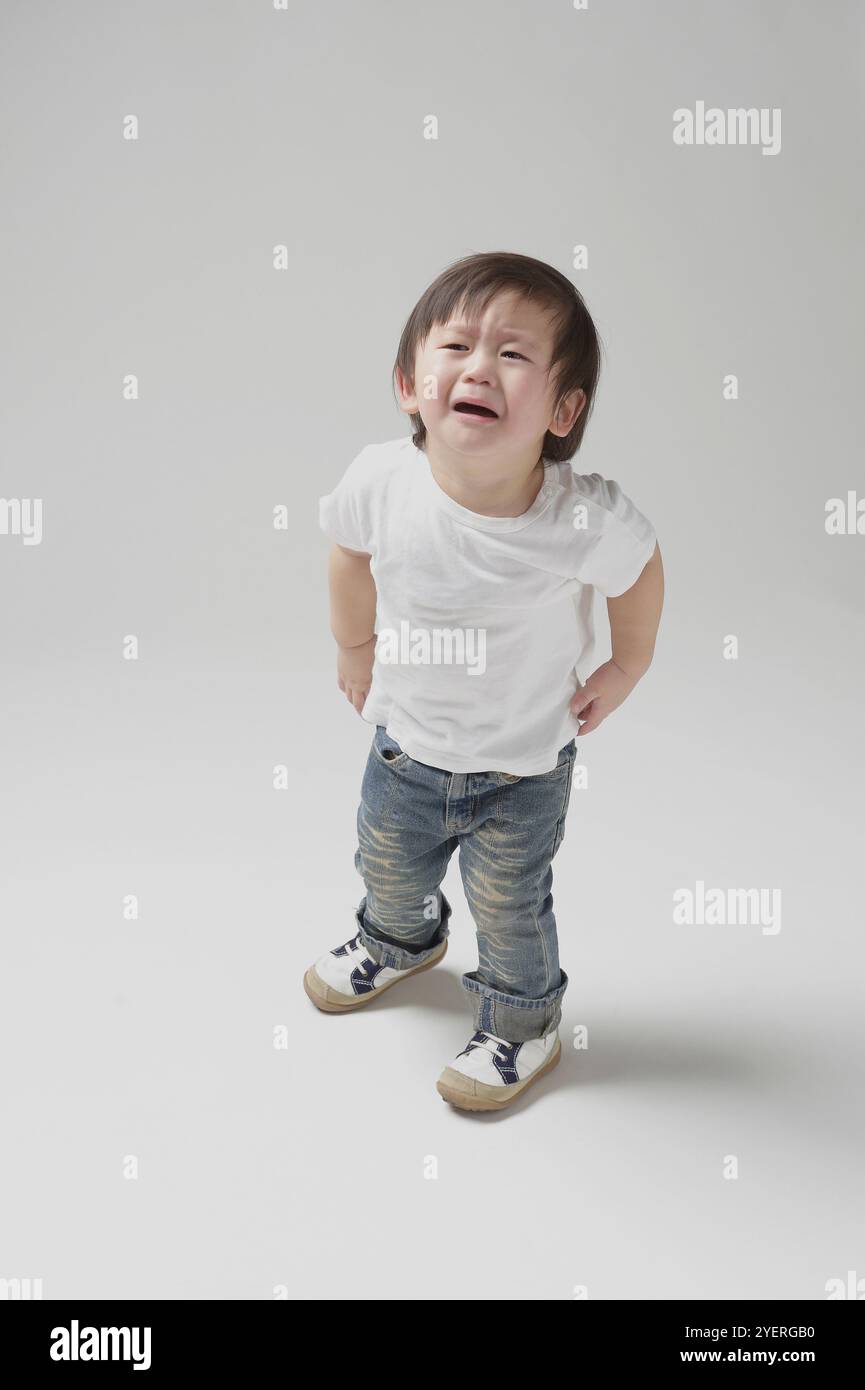 A two year old boy looking up with a half-crying face Stock Photo - Alamy