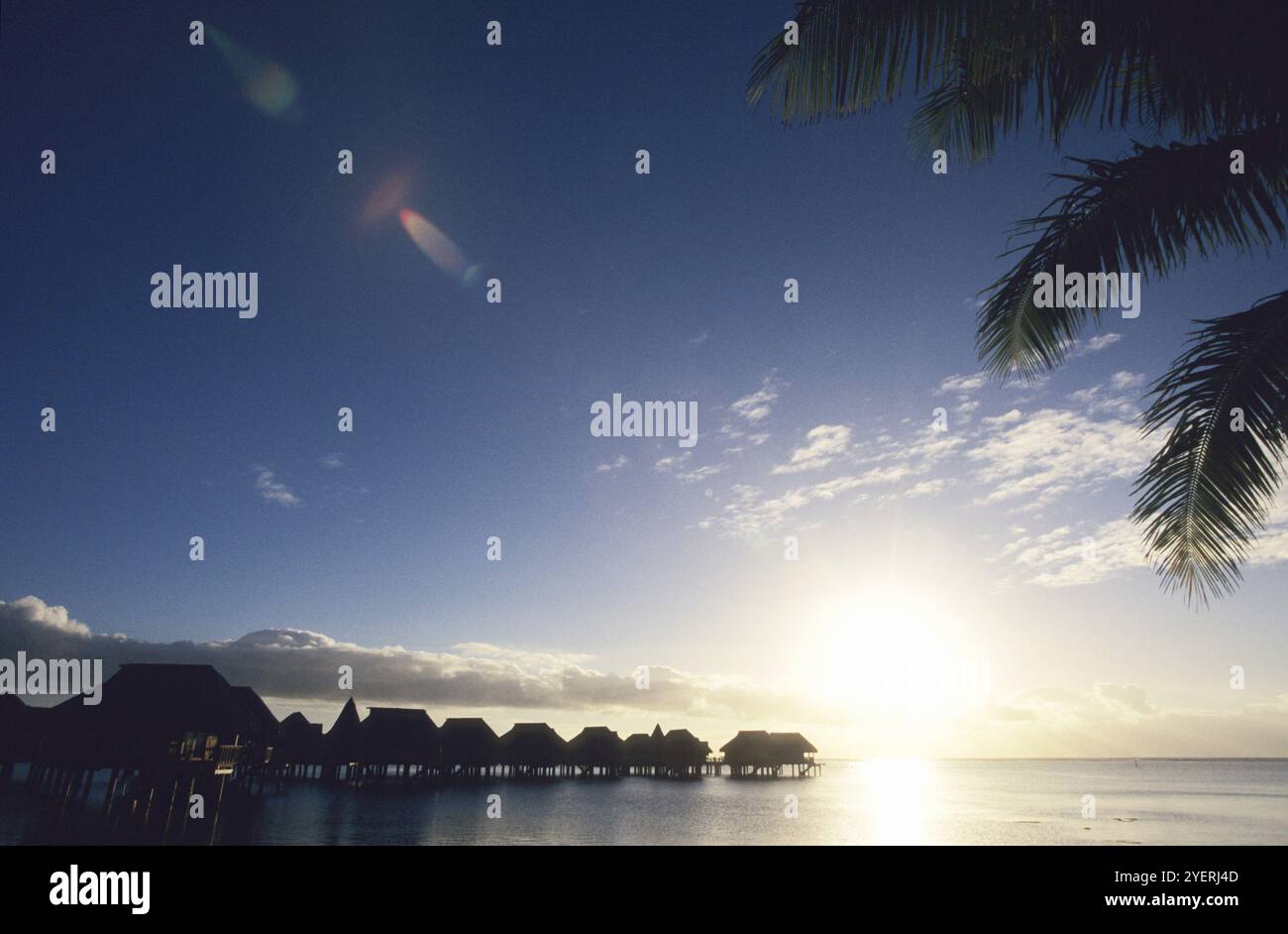 The sun and a cottage on the water Stock Photo - Alamy