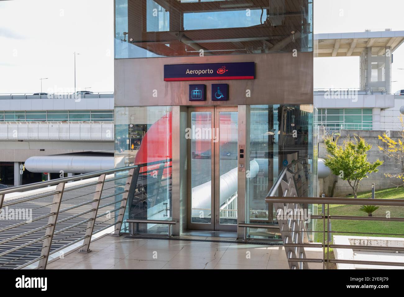 Transparent elevator with open doors, located in a modern airport ...