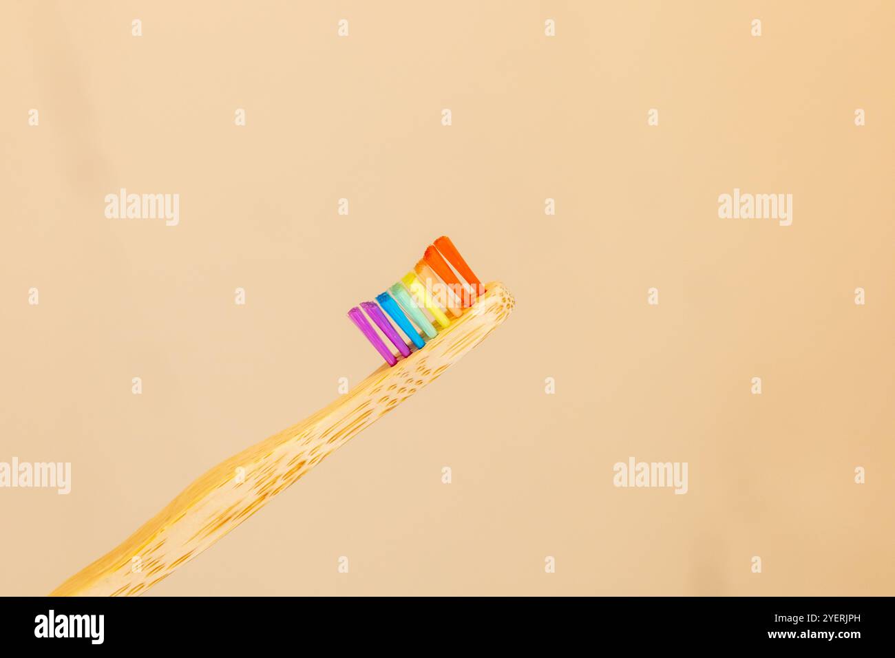 Vibrant rainbow toothbrush against a neutral background for effective ...
