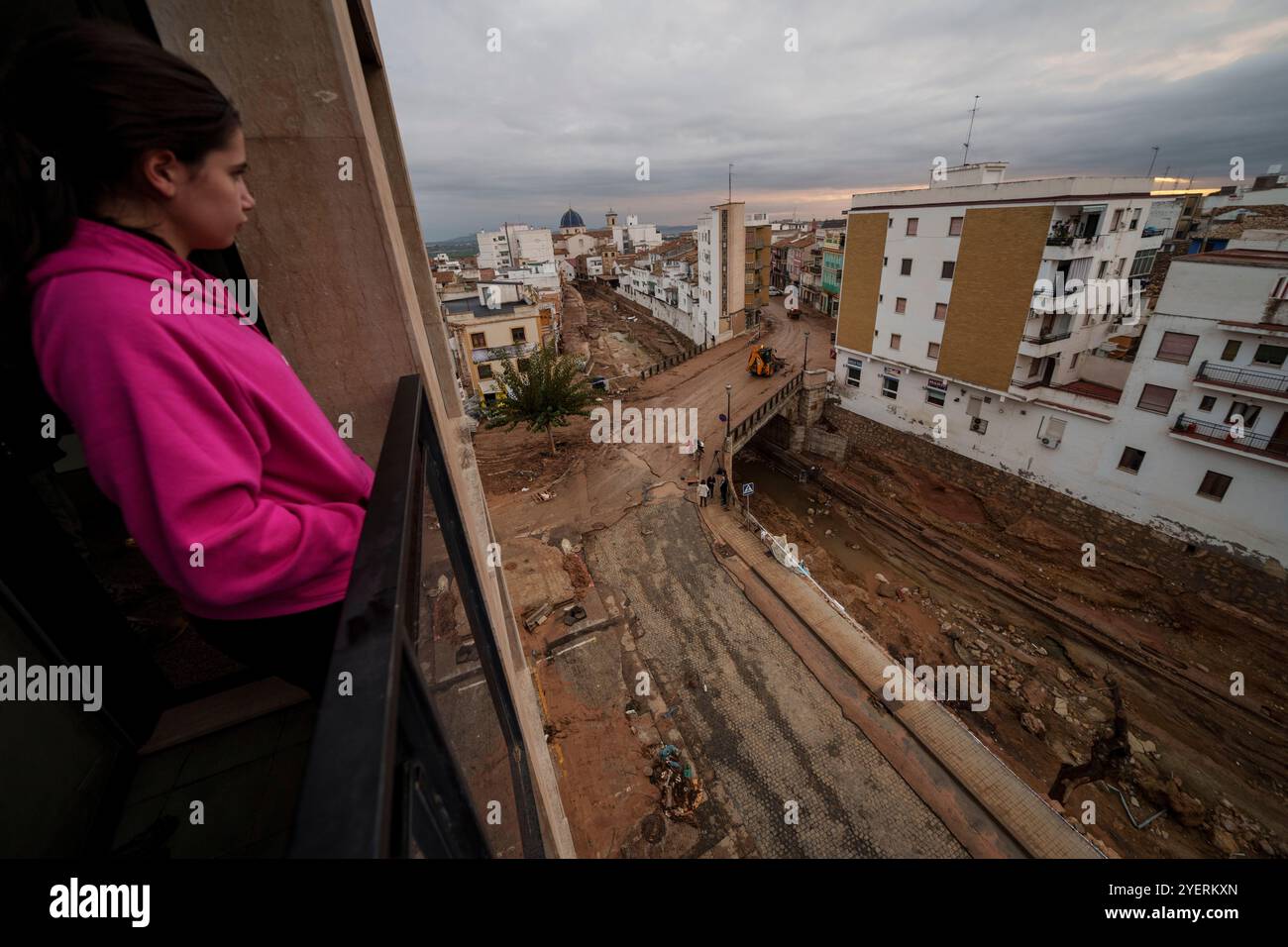 A woman looks out over an area affected by floods in Chiva, Spain ...