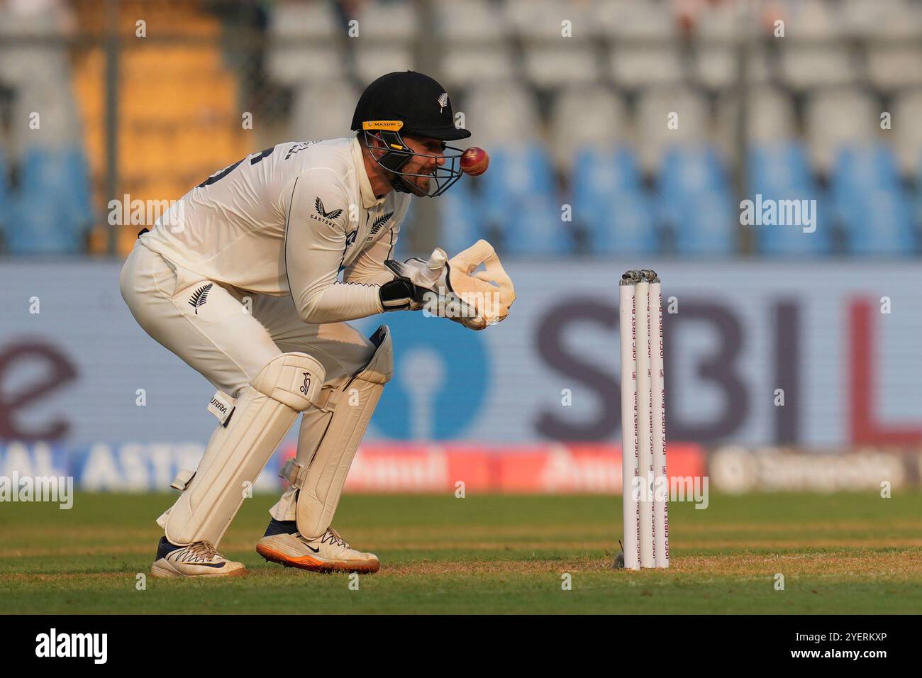 The ball hits the helmet of New Zealand's wicketkeeper Tom Blundell ...