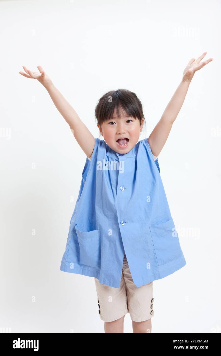Kindergarten girl doing banzai Stock Photo - Alamy