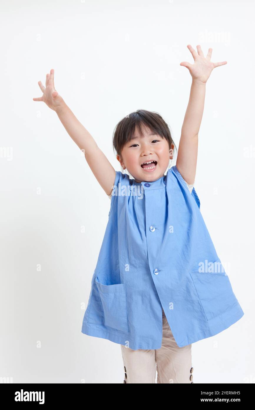 Kindergarten girl doing banzai Stock Photo - Alamy