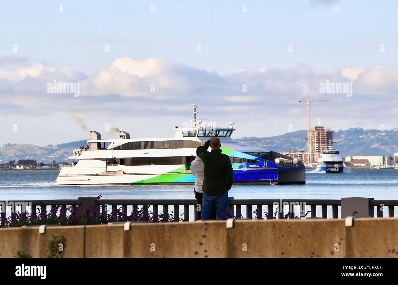 People watching the Hydrus ferry boat arriving to the downtown ferry ...