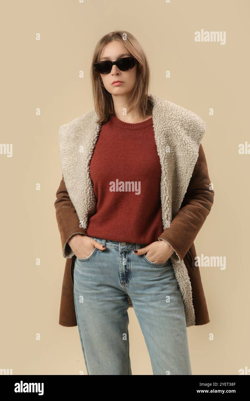 Serie of studio photos of woman in classic autumn winter casual outfit - blue jeans and ...