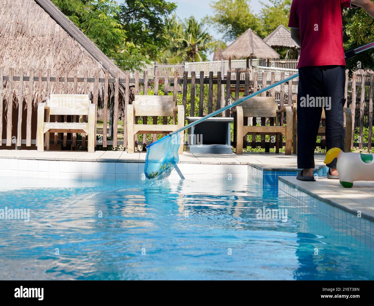 Cleaning pool, A man with cleaning equipment on hand for swimming pool ...