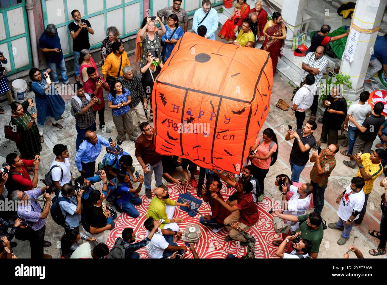 Kolkata, India. 31st Oct, 2024. People release a paper lantern with ...