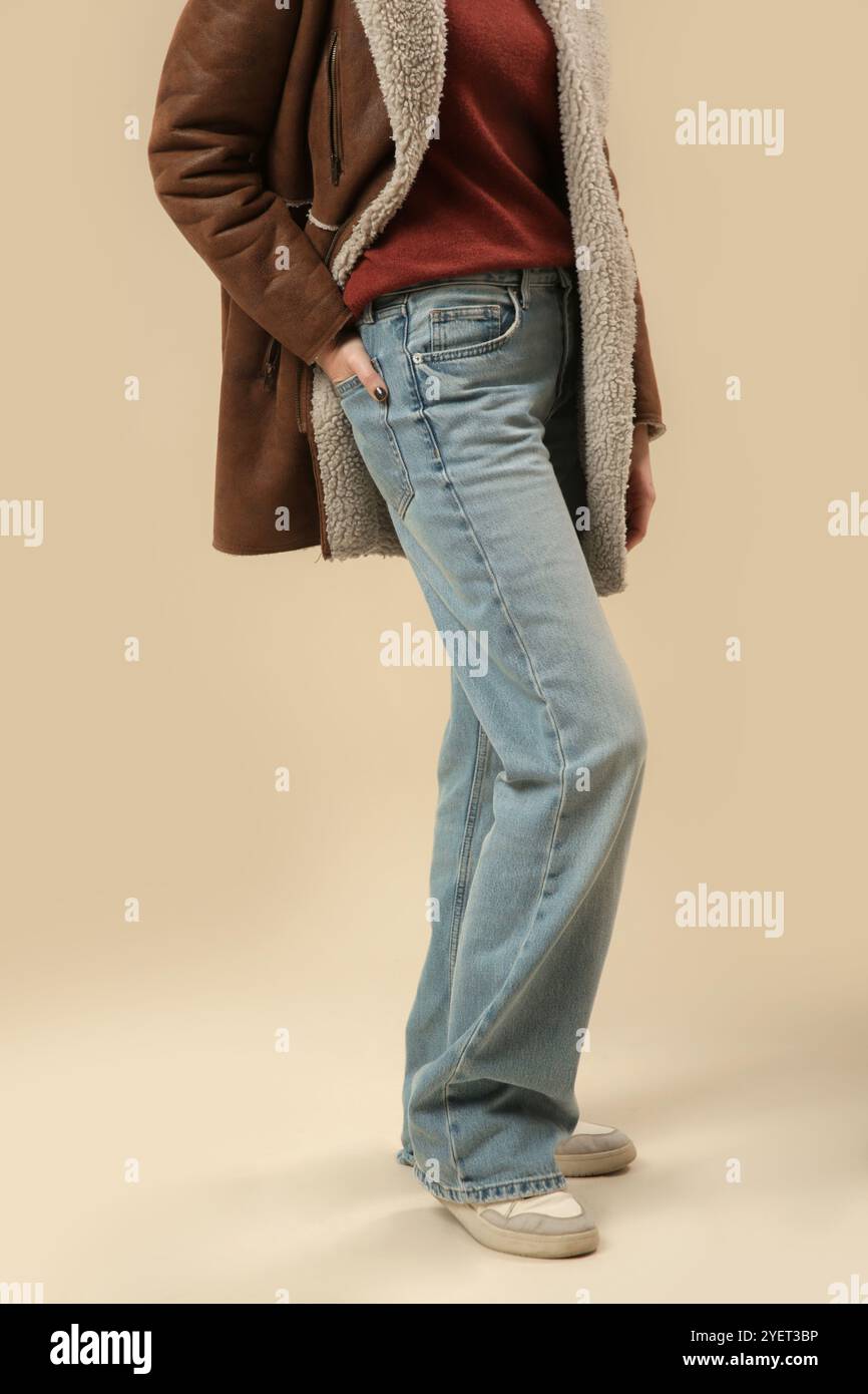Serie of studio photos of woman in classic autumn winter casual outfit - blue jeans and ...